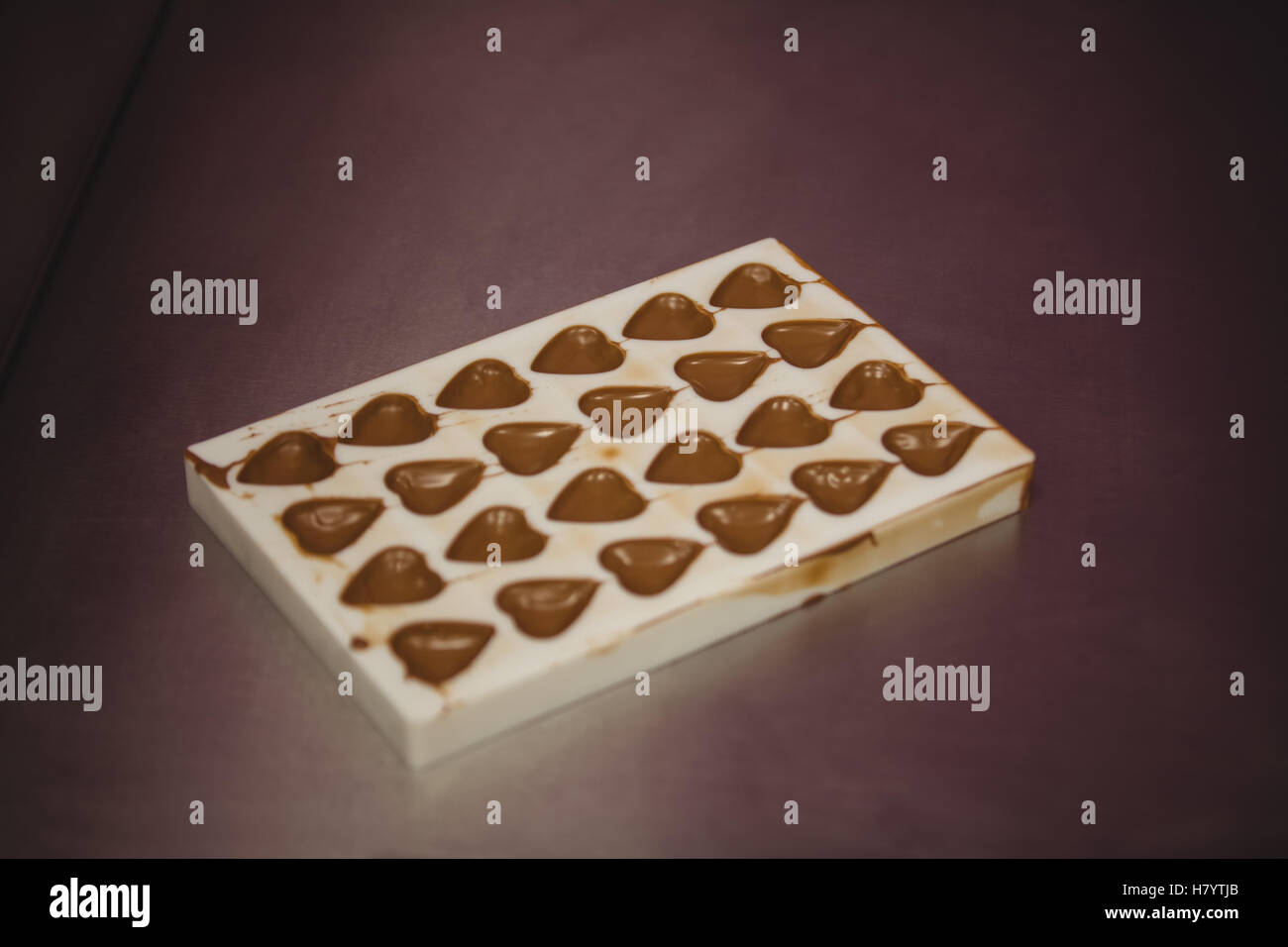 Close-up of mould filled with melted chocolate Stock Photo - Alamy