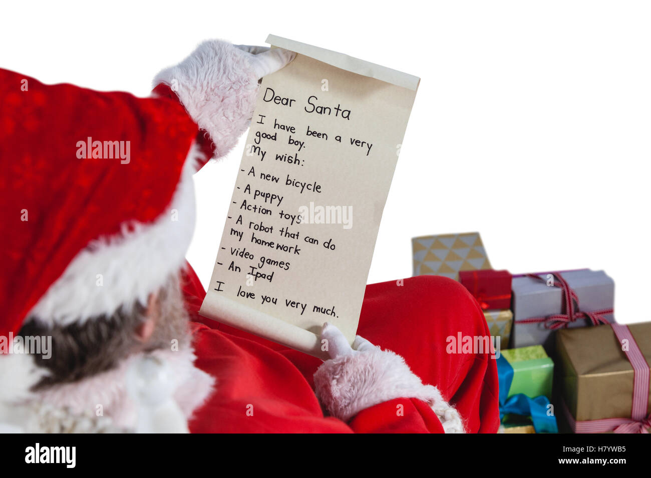 Santa claus reading a letter Stock Photo - Alamy