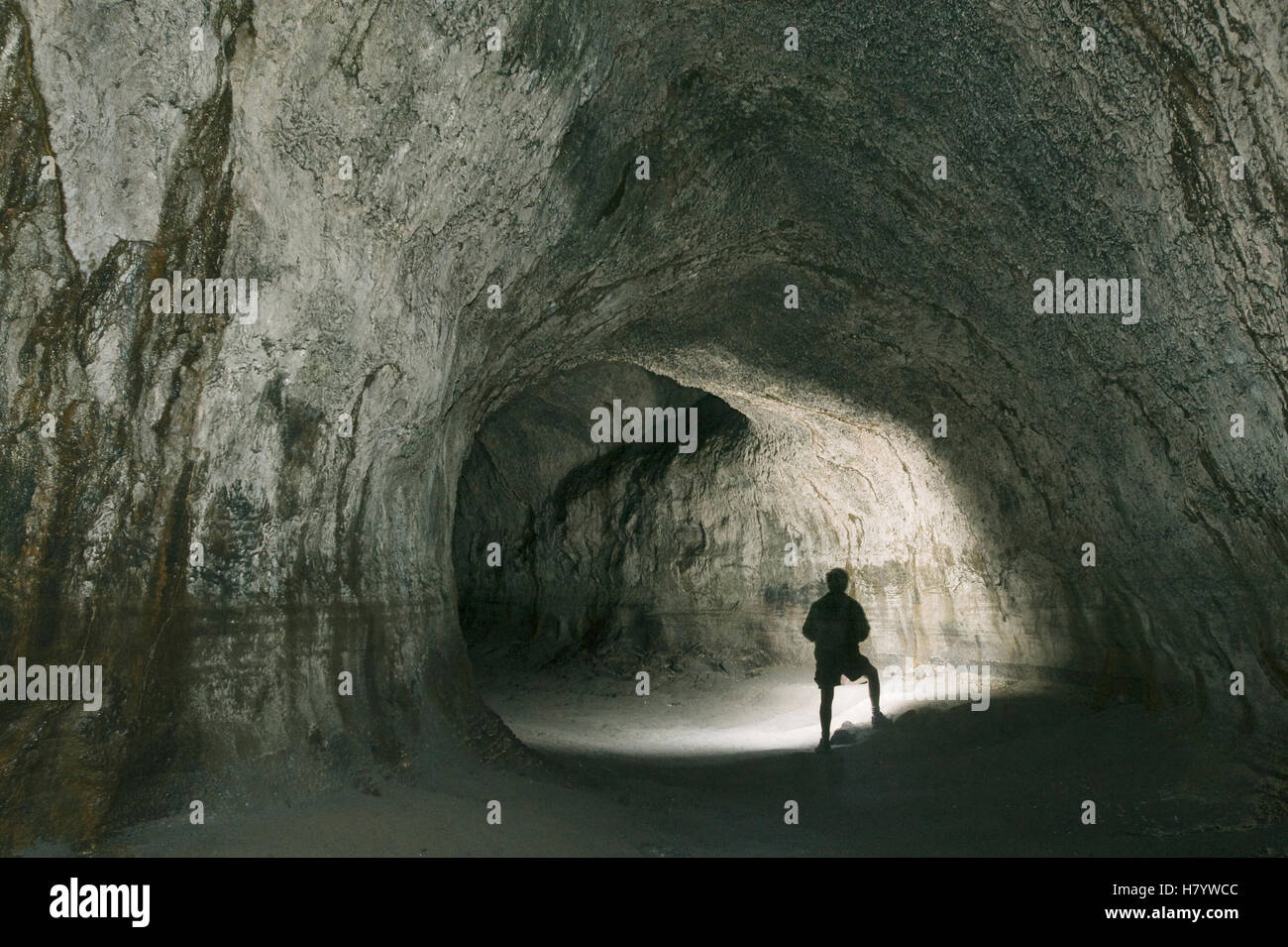 Lava tube and person in Ape Cave, Mount St Helens Volcano National ...