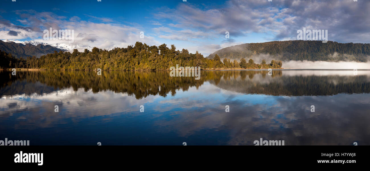 Lake Mapourika with mist rising off water, Westland National Park, New ...