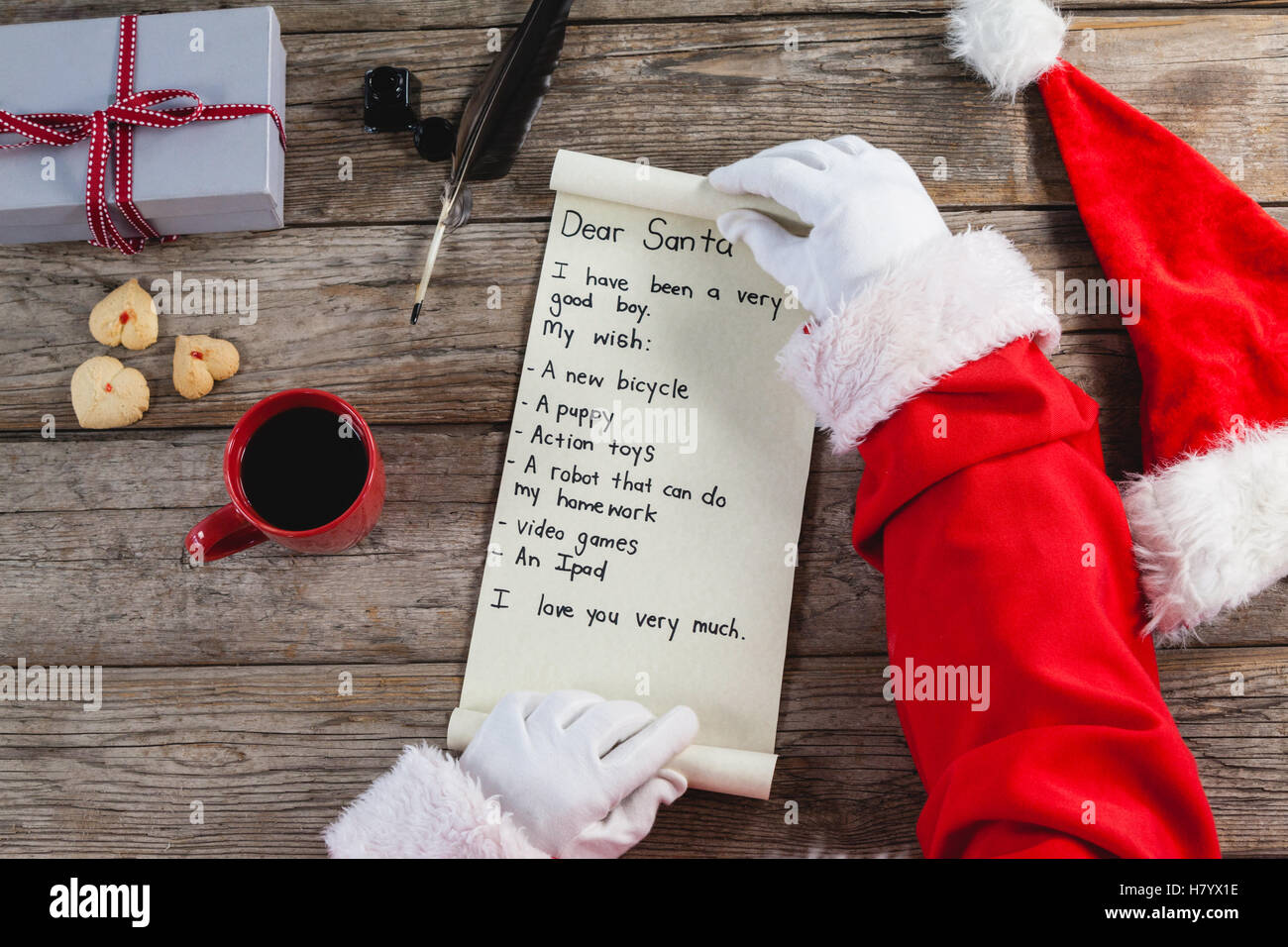 Close-up of santa claus opening scroll Stock Photo - Alamy