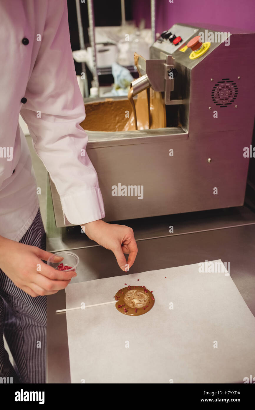 Worker preparing lollipop on wax paper Stock Photo - Alamy