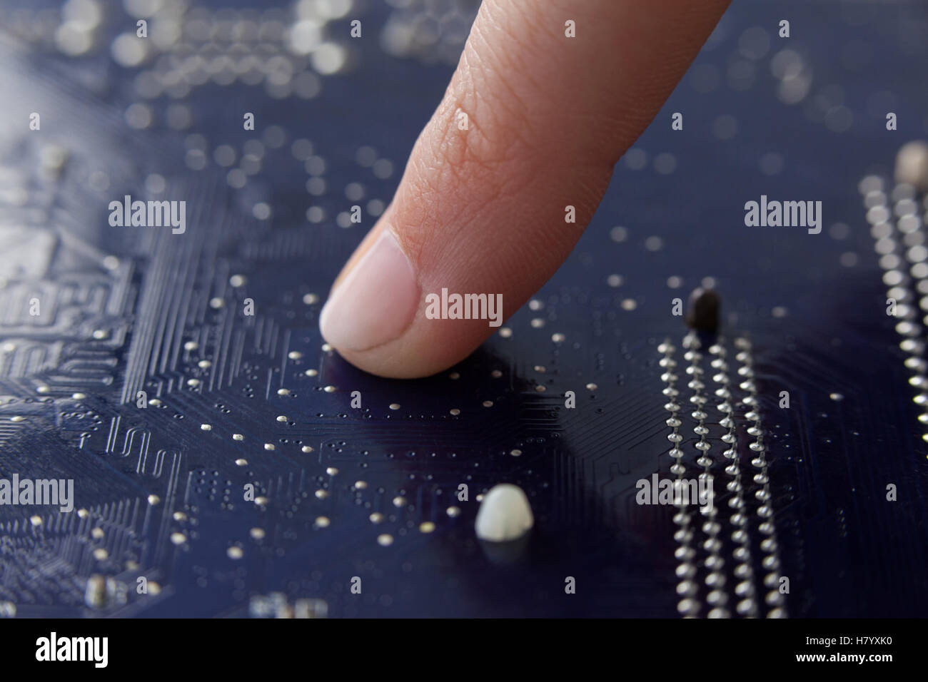 Hand of a woman touching motherboard Stock Photo - Alamy
