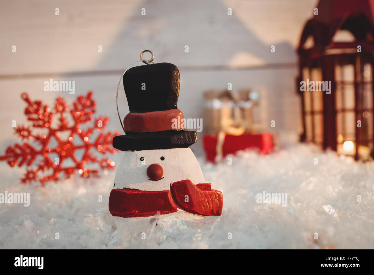 Snowman and christmas decorations on fake snow Stock Photo - Alamy