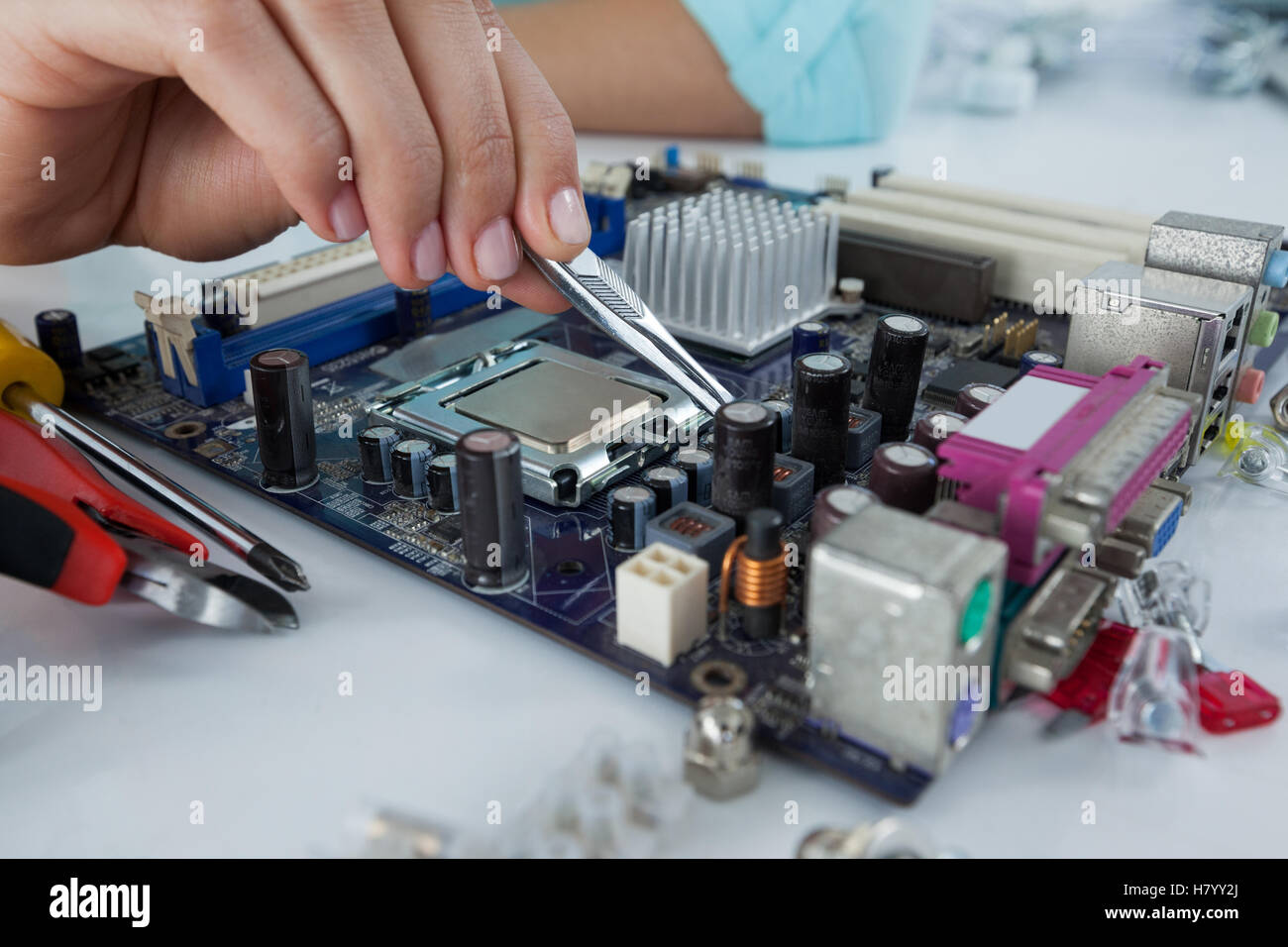 Female computer engineer repairing computer motherboard Stock Photo - Alamy