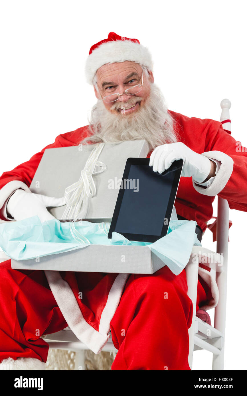 Santa claus removing digital tablet from gift box Stock Photo - Alamy