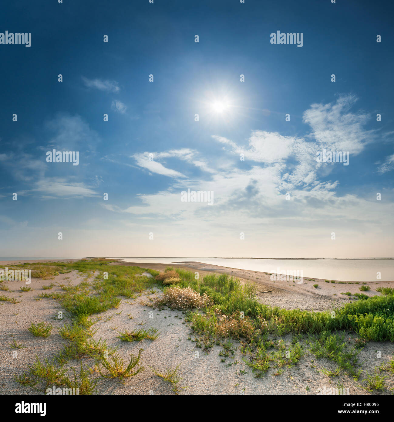 Sandy beach and sun, landscape Stock Photo - Alamy