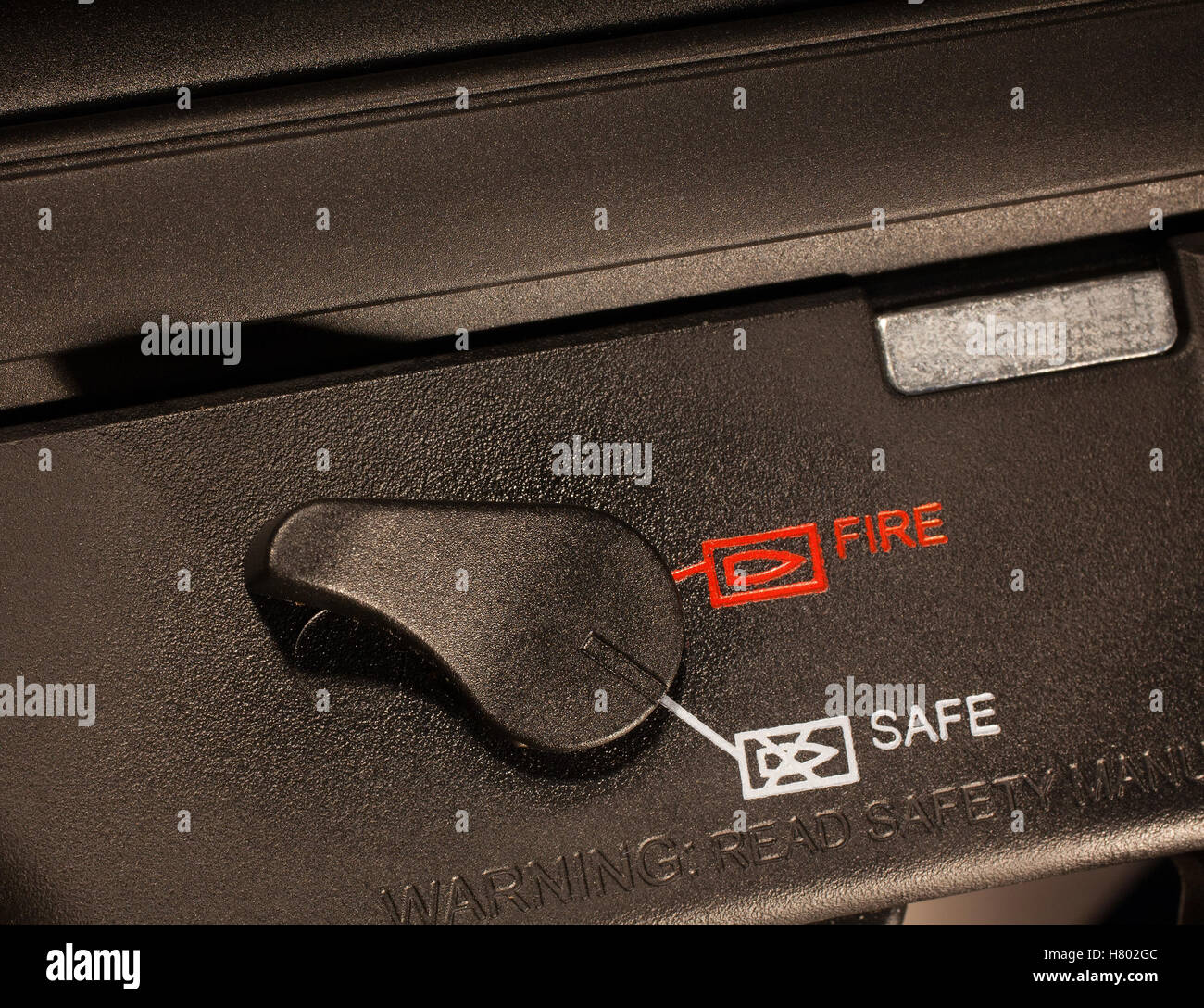 Safety lever on an assault rifle that is on the safe position Stock ...