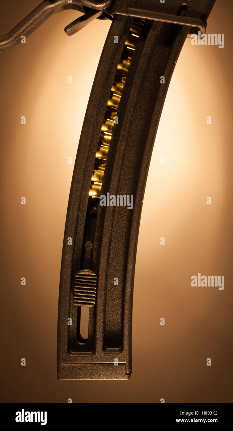 Magazine loaded with many bullets with a tan background Stock Photo - Alamy