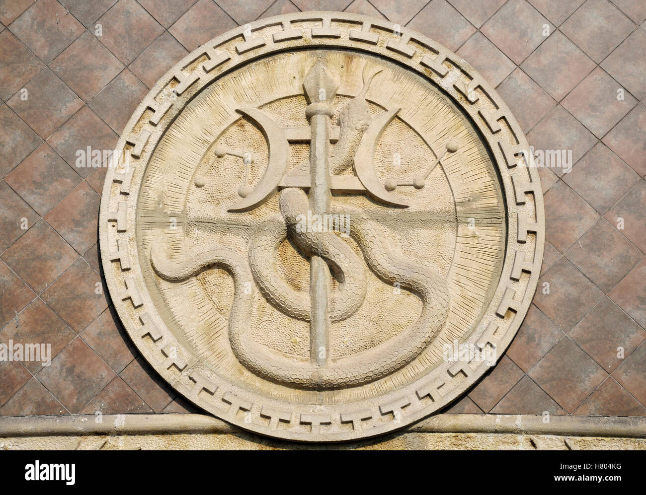 A stone snake mural on the outside of a building in Wuyi China in ...