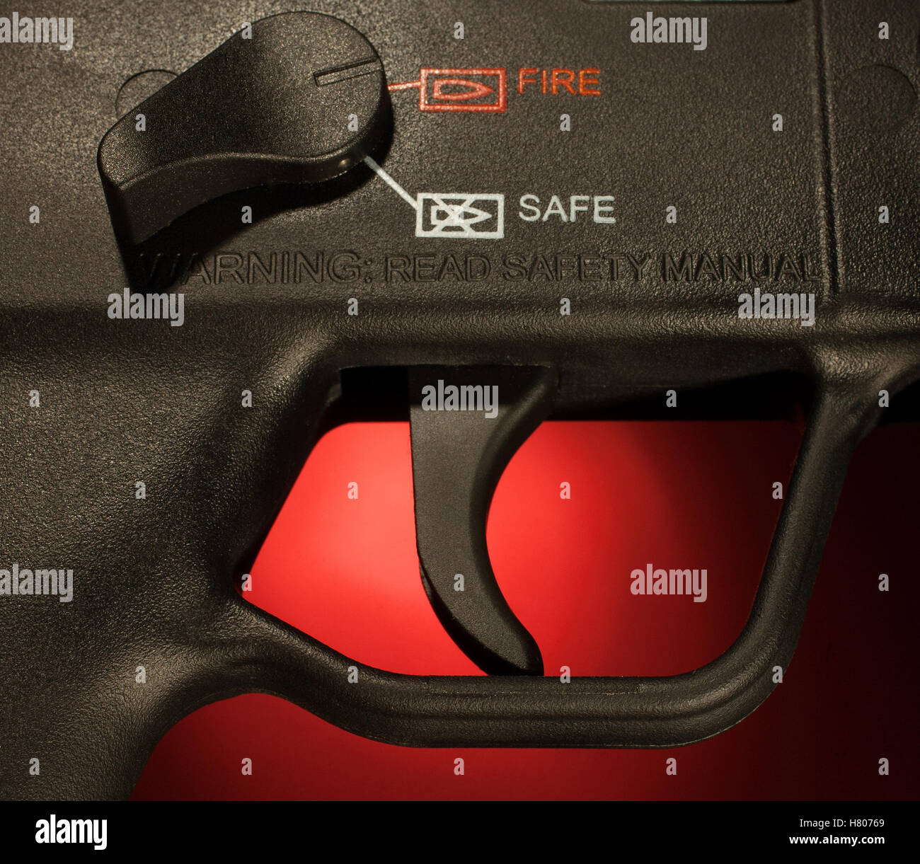 Safety and trigger on an assault rifle with a red background Stock ...