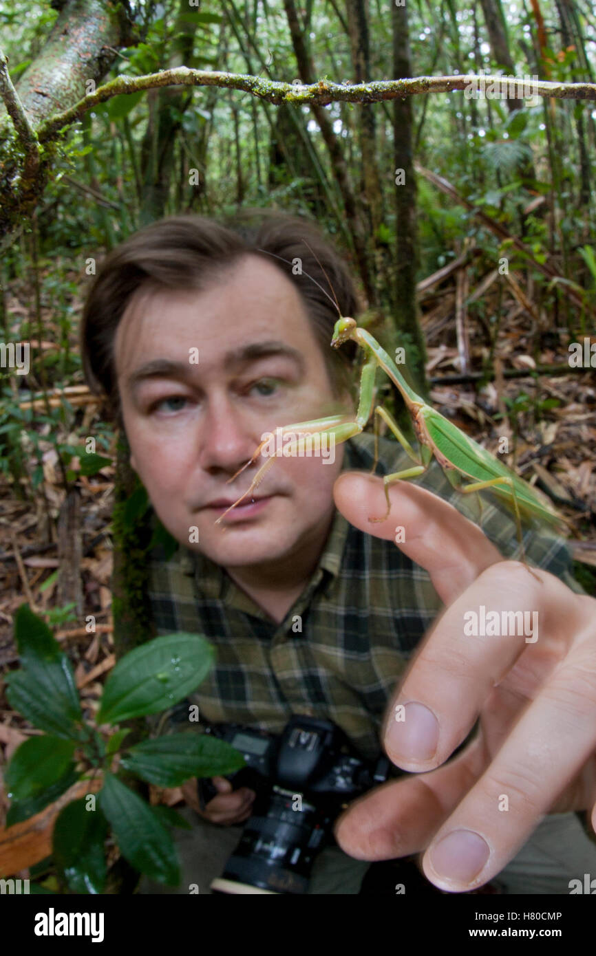 Piotr Naskrecki with praying mantis, Nakanai Mountains, Papua New ...