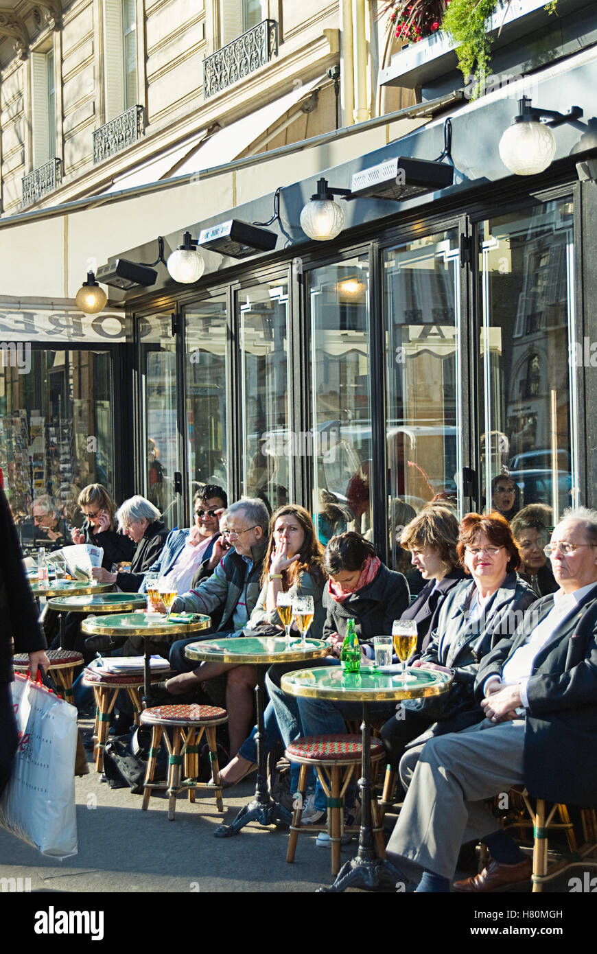 People sitting outdoors at a cafe in Paris, France Stock Photo - Alamy