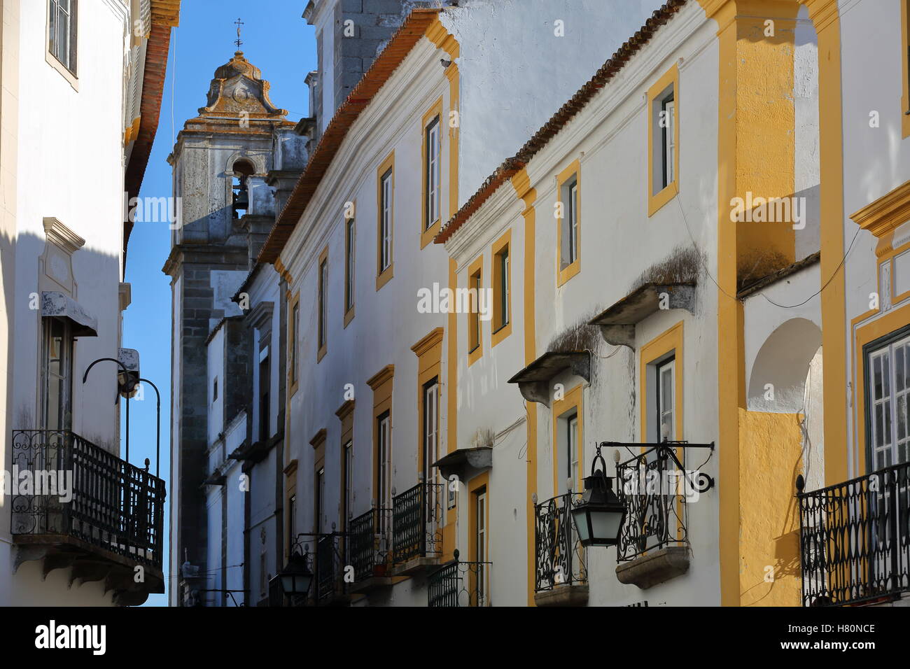 EVORA, PORTUGAL: typical narrow street with houses painted in white and ...