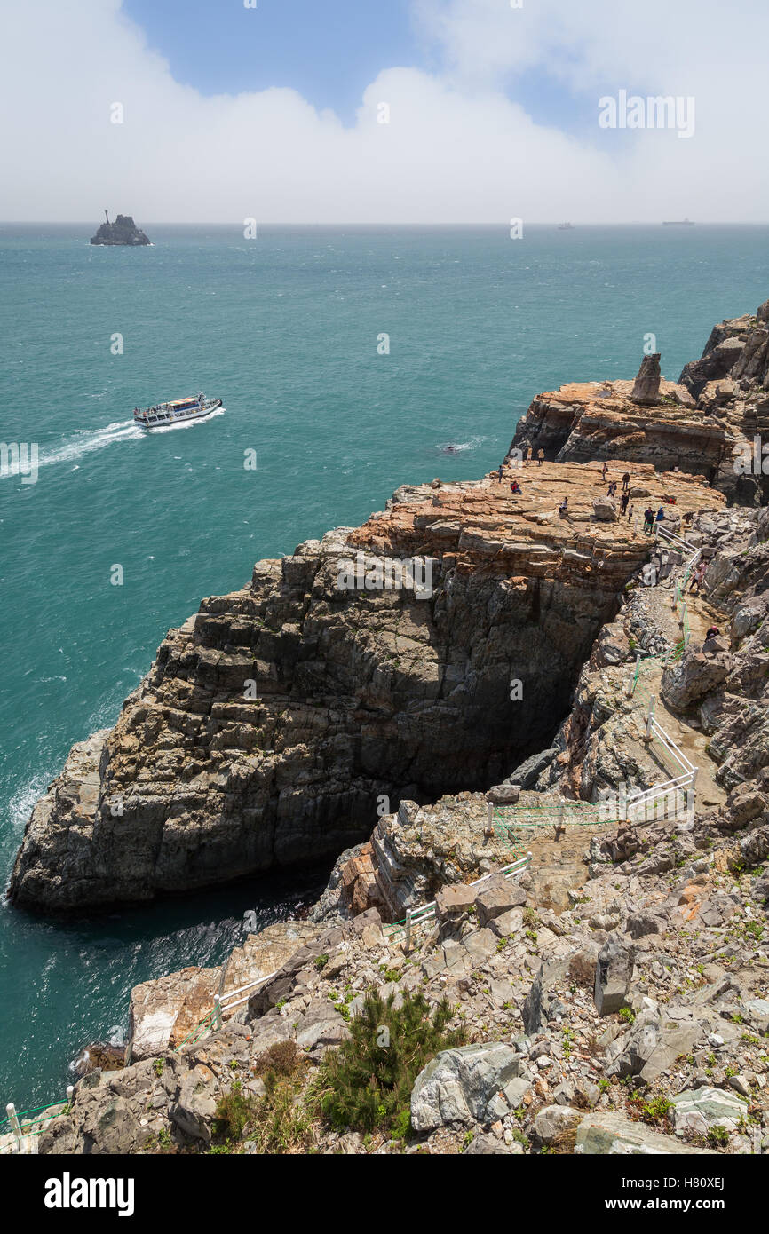 Rocky, rugged and steep cliff, ocean and people at the Taejongdae ...