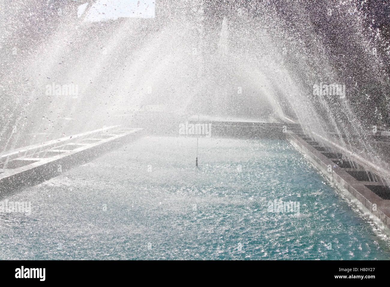 Fountain waterflow and drops against sunlight Stock Photo - Alamy