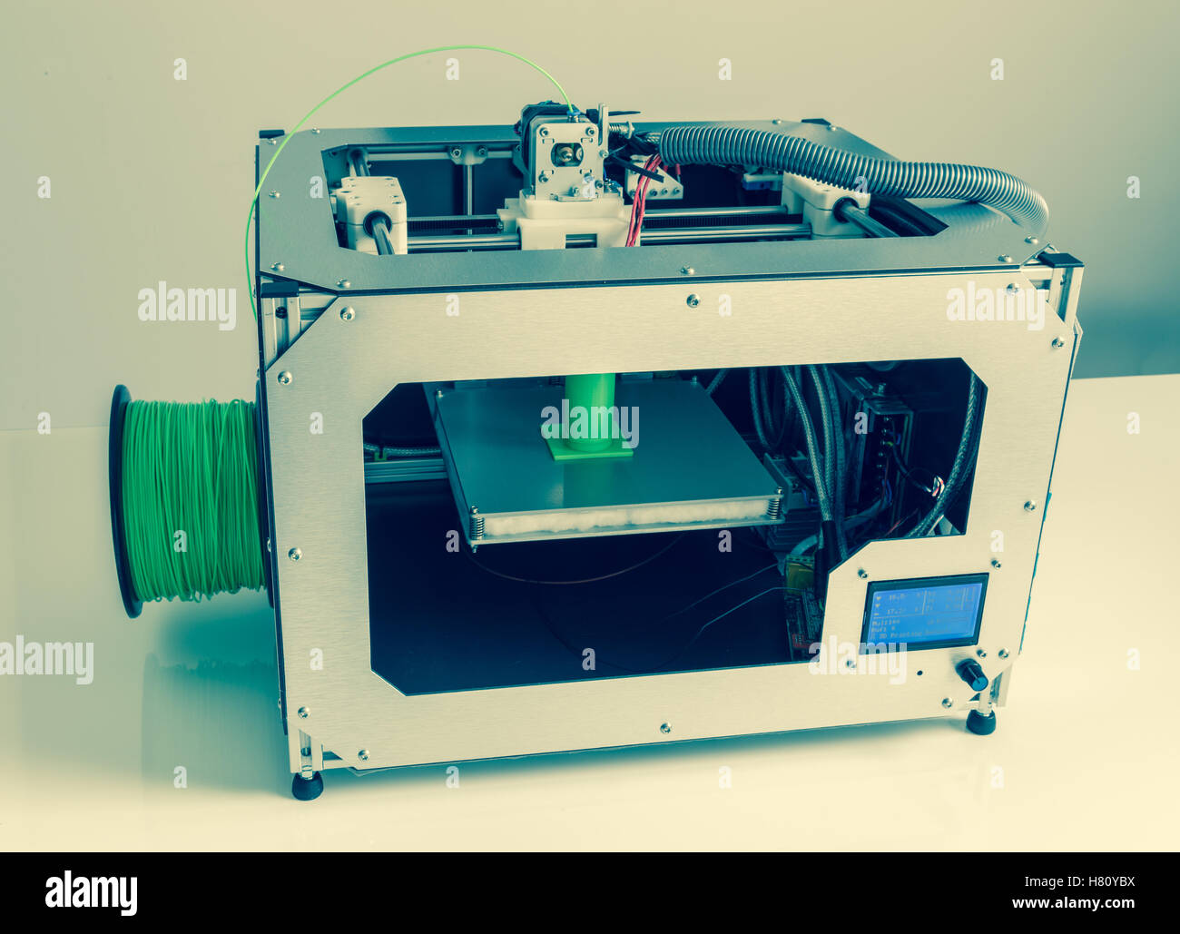 3d printer with bright green filament Stock Photo - Alamy