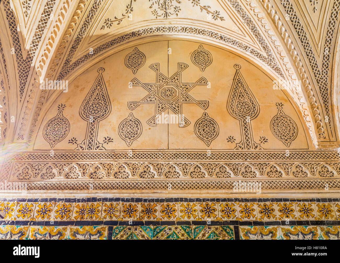 The floral islamic patterns made of carved plaster and glazed tiles in ...
