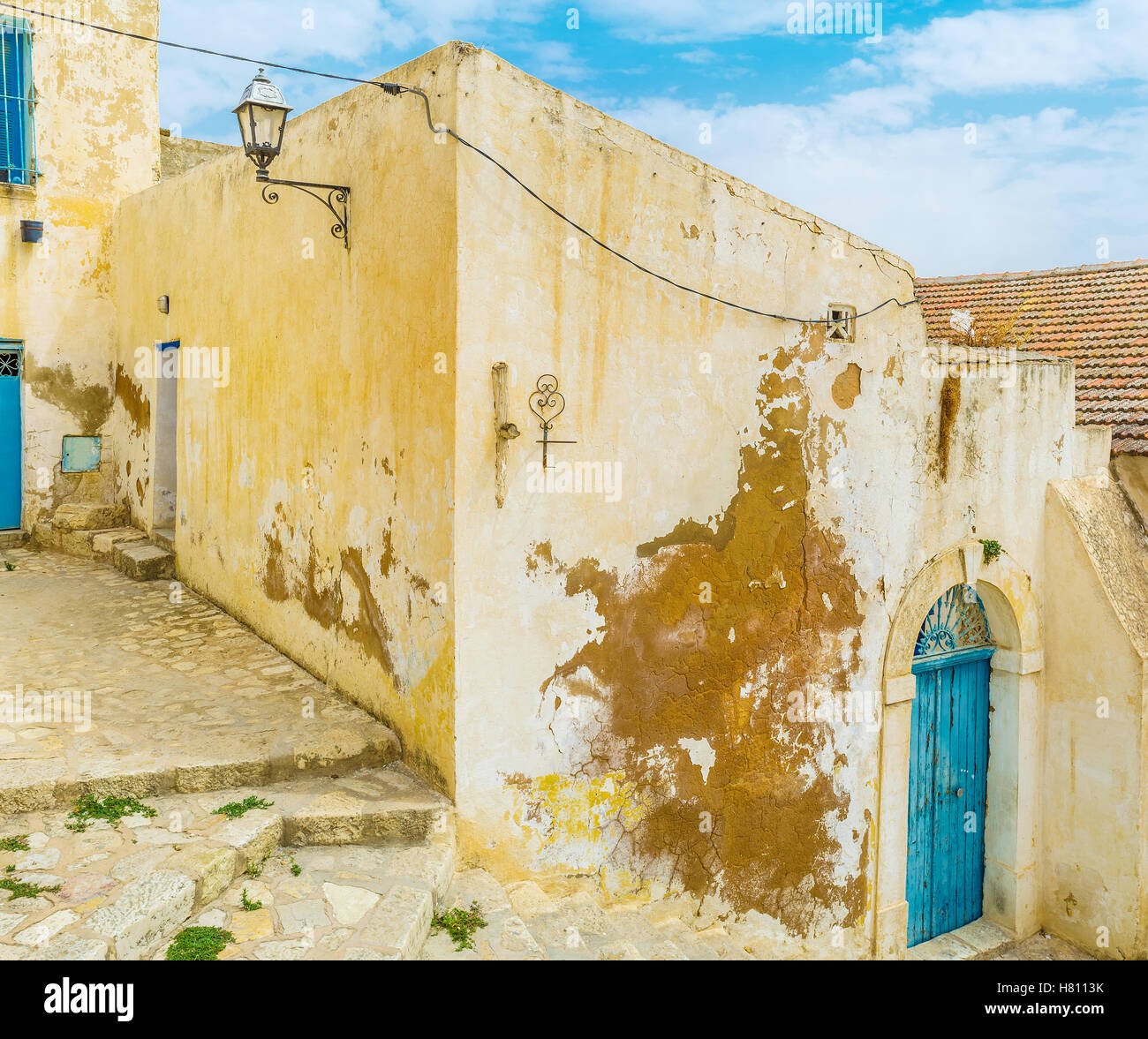 The old building of Al-Ghriba synagogue on the hilly street in old El ...