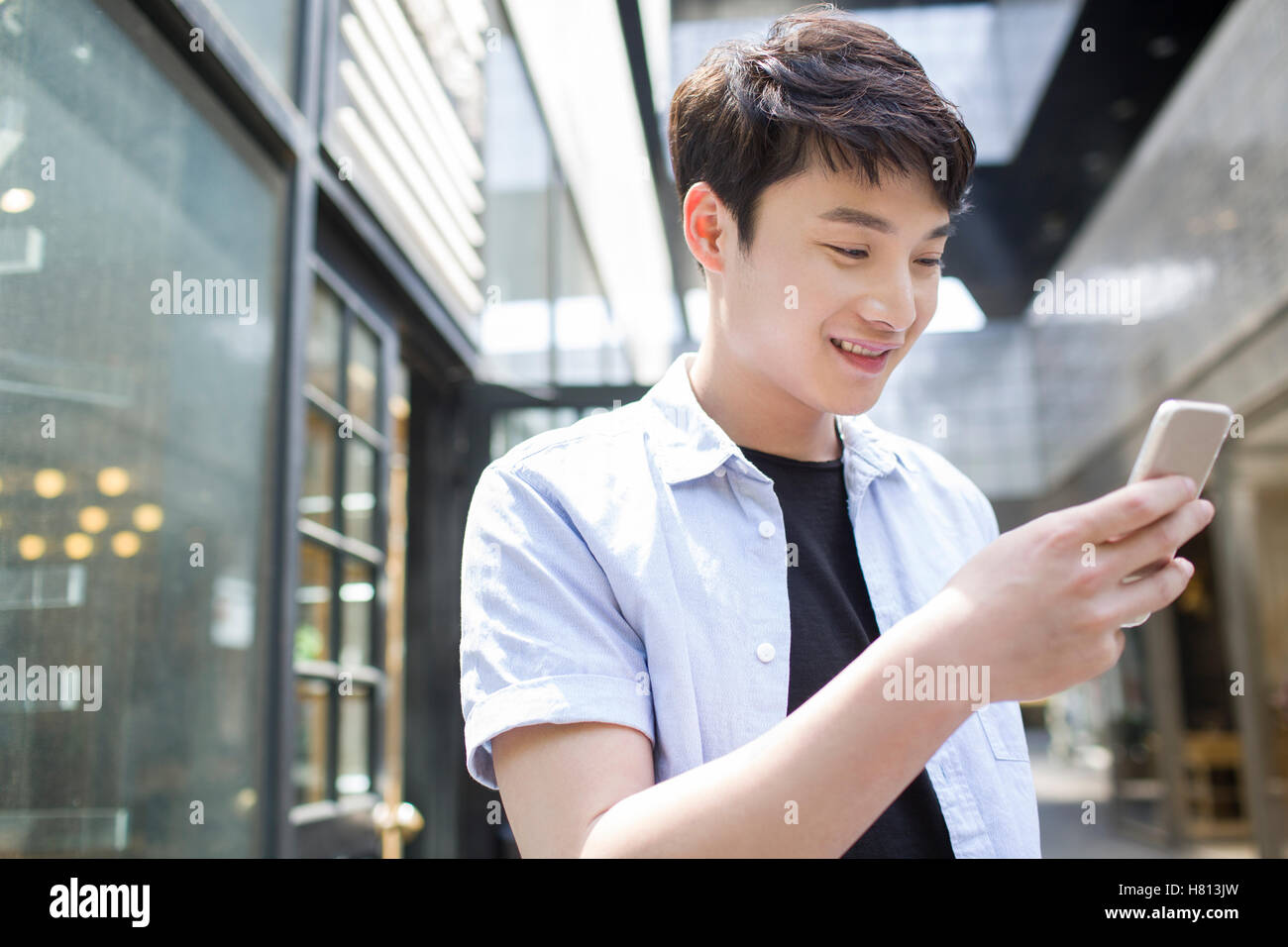 Young Chinese man using a smart phone Stock Photo - Alamy