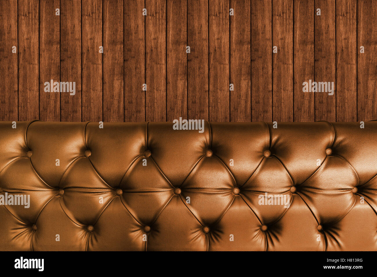 background with close-up of dark brown leather seat and dark wood wall ...