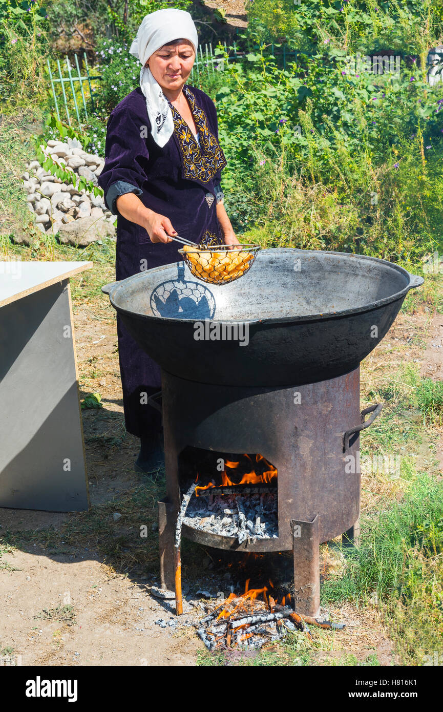 Kazakh Woman preparing the traditional local tandyr bread, Shymkent ...