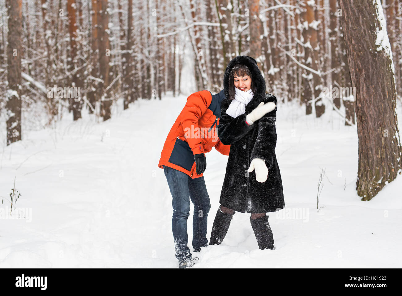 Young couple playing in snow, having snowball fight Stock Photo - Alamy