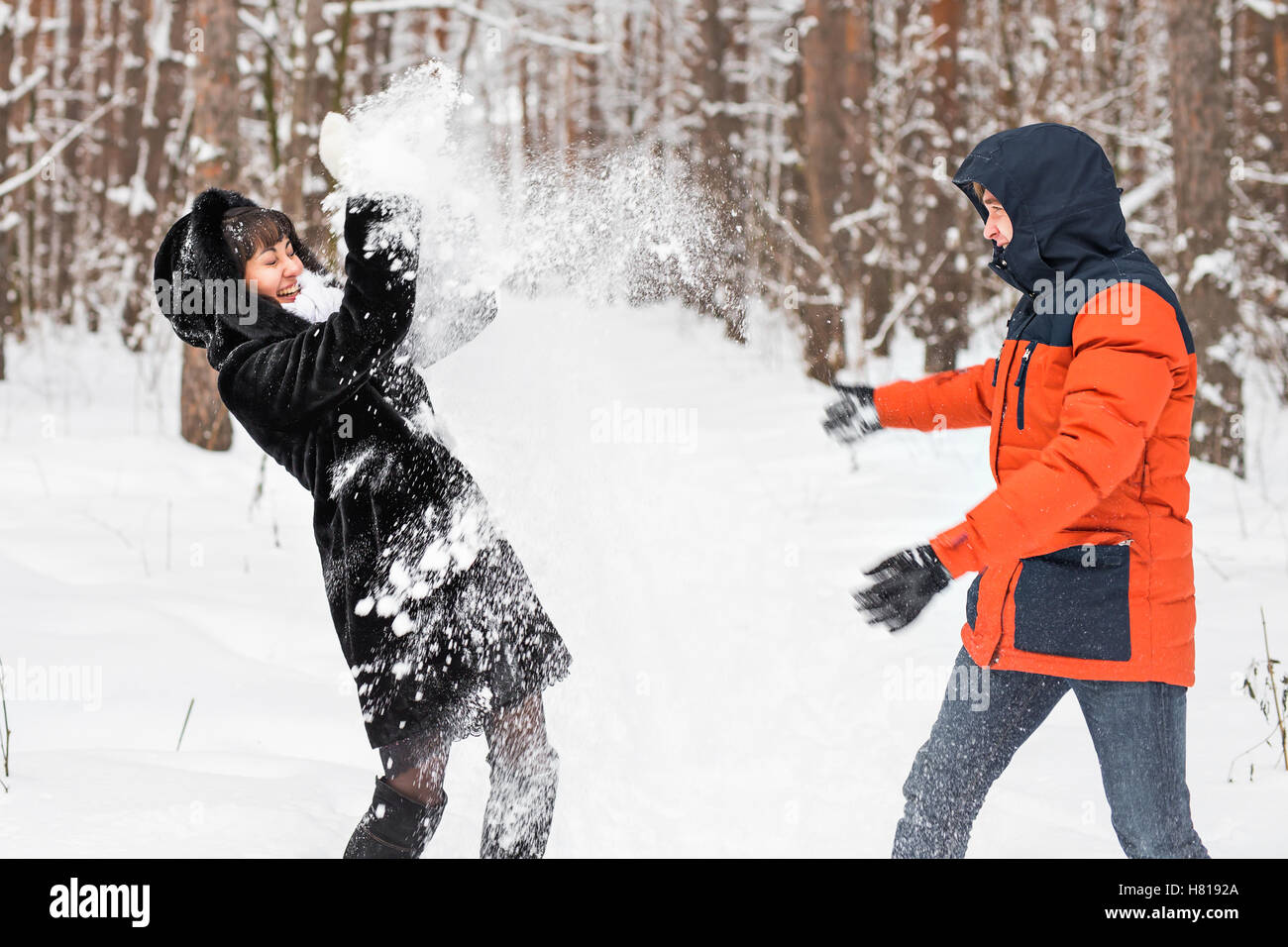 Young couple having snowball fight hi-res stock photography and images ...