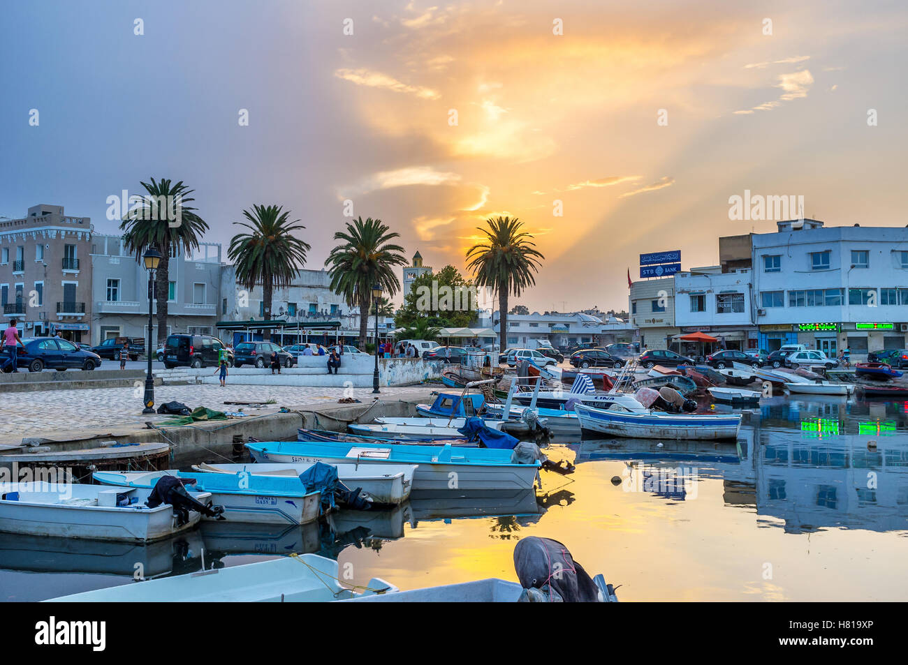 The beautiful sunset over the old port reflects in water Stock Photo ...