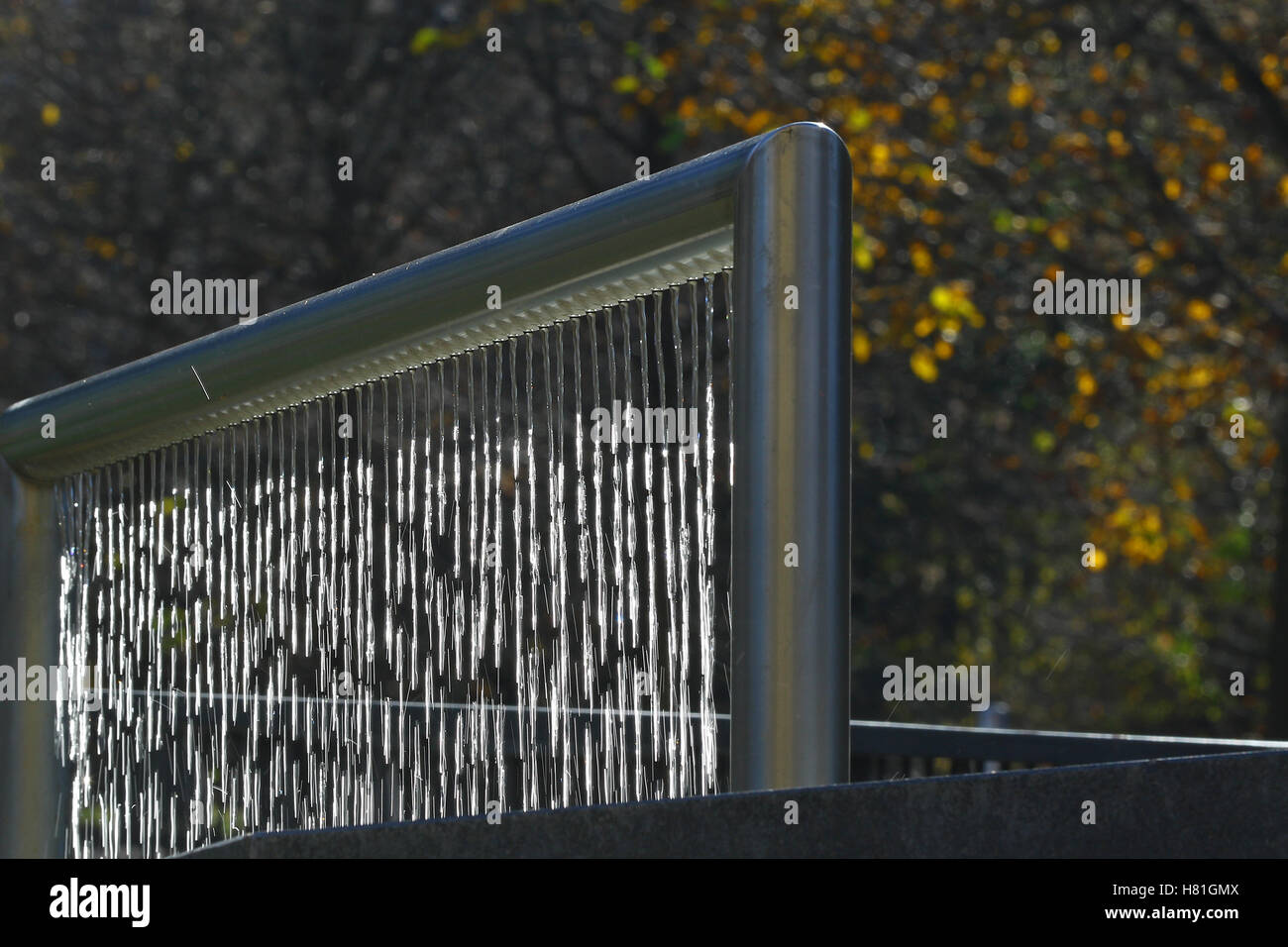 Water curtain dripping and splashing from modern fountain motion blur ...