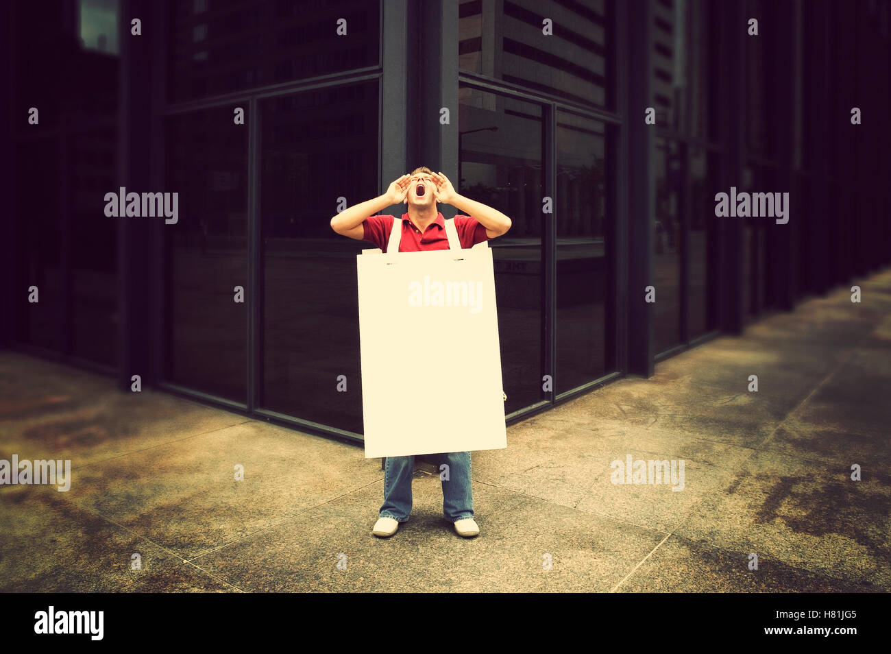 man wearing message board yelling Stock Photo - Alamy