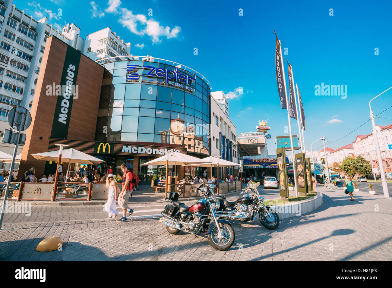 Minsk, Belarus. Young Couple Sets Eyes On Two Chopper Style Motorcycles ...