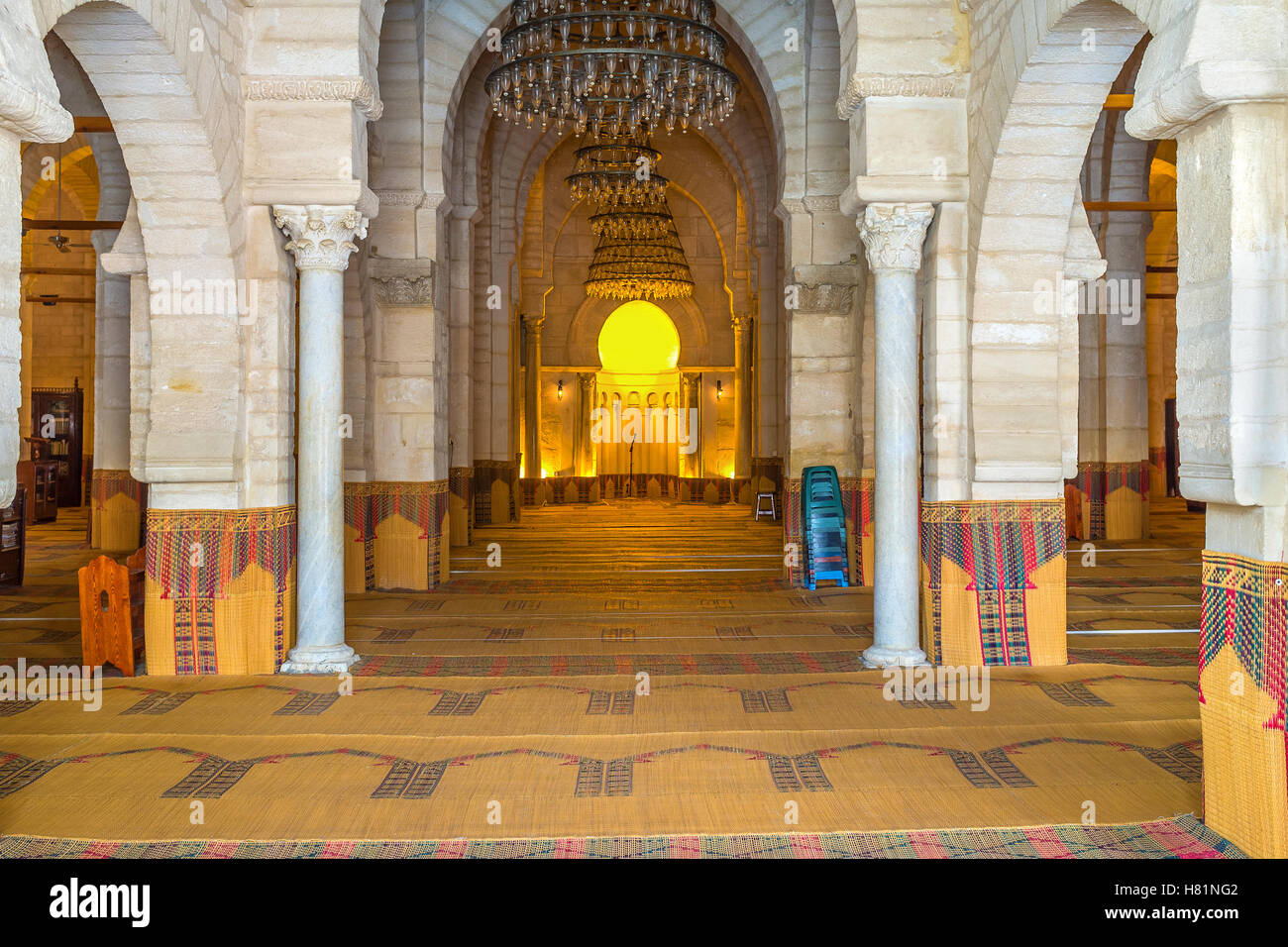 The stone mihrab in the Grand Mosque in bright yellow illumination ...