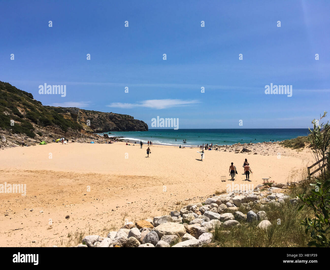 Portuguese Beach with sunbathing People and Surfers Stock Photo - Alamy
