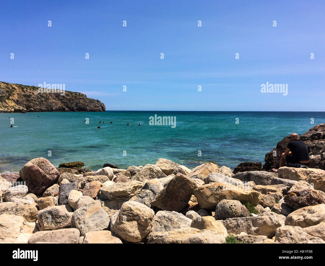 Portuguese Beach with sunbathing People and Surfers Stock Photo - Alamy