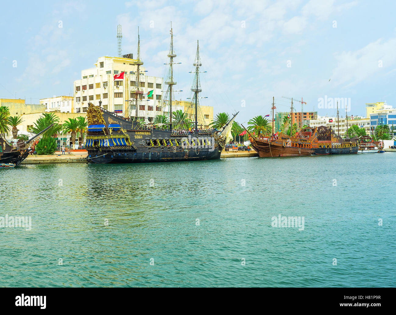 The old wooden galleons with modern city buildings on the background ...
