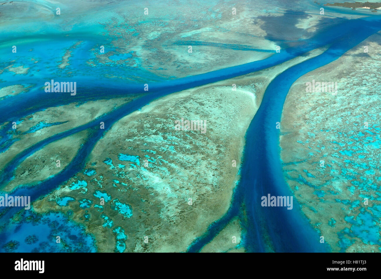 Aerial view of tidal channels in coral which feed central lagoon ...