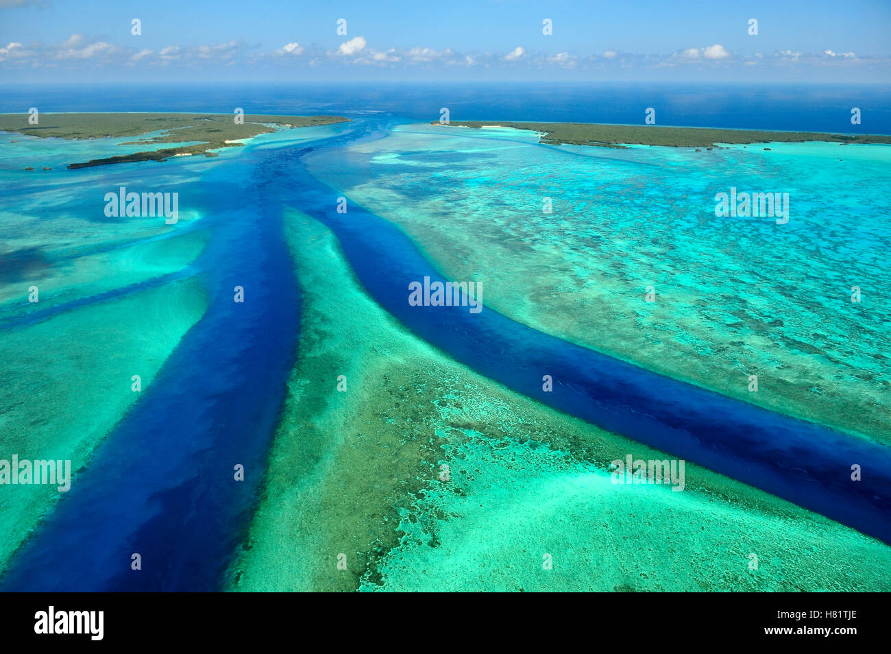 Aerial view of tidal channels in coral which feed central lagoon ...