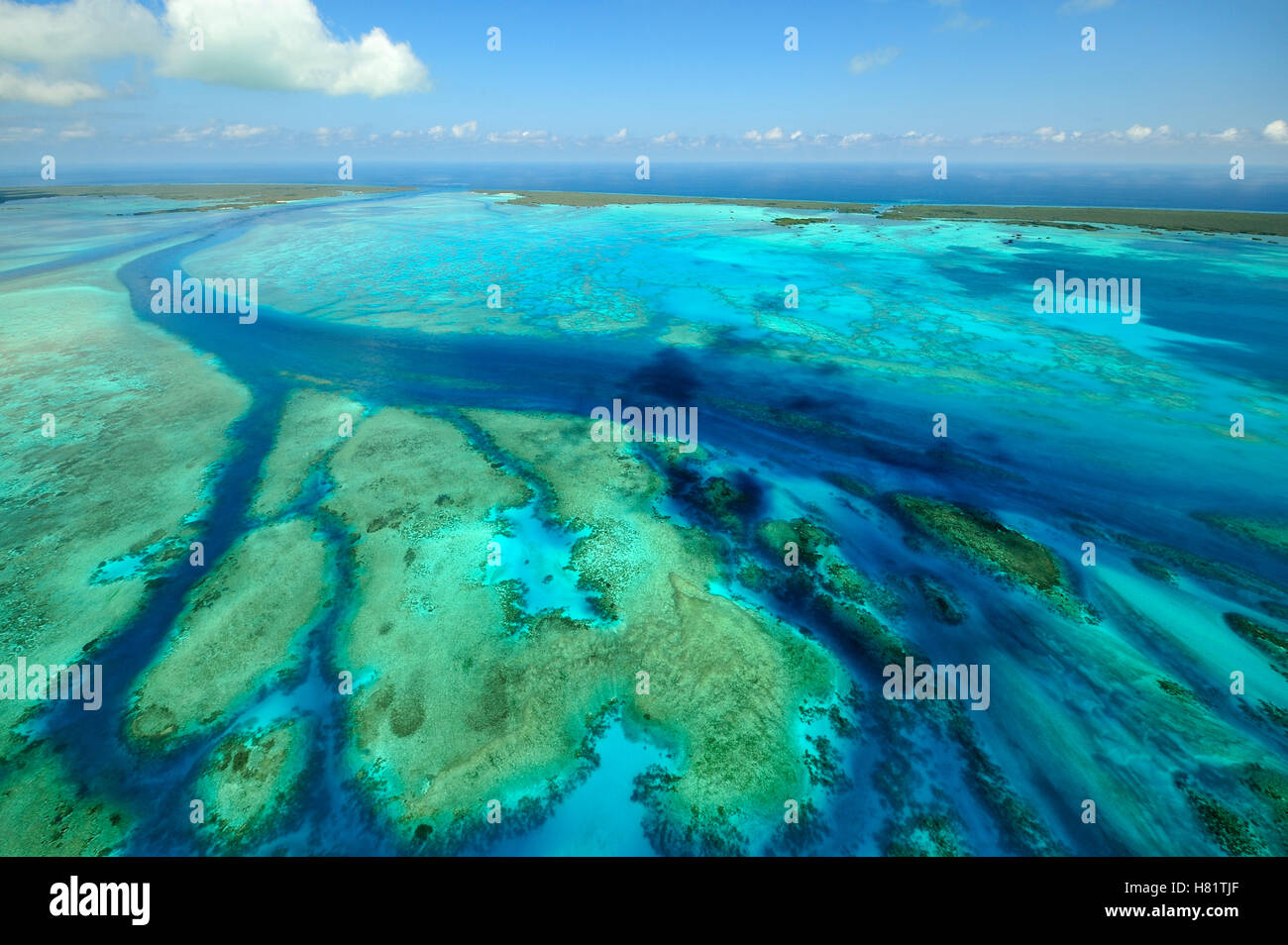 Aerial view of tidal channels in coral which feed central lagoon ...