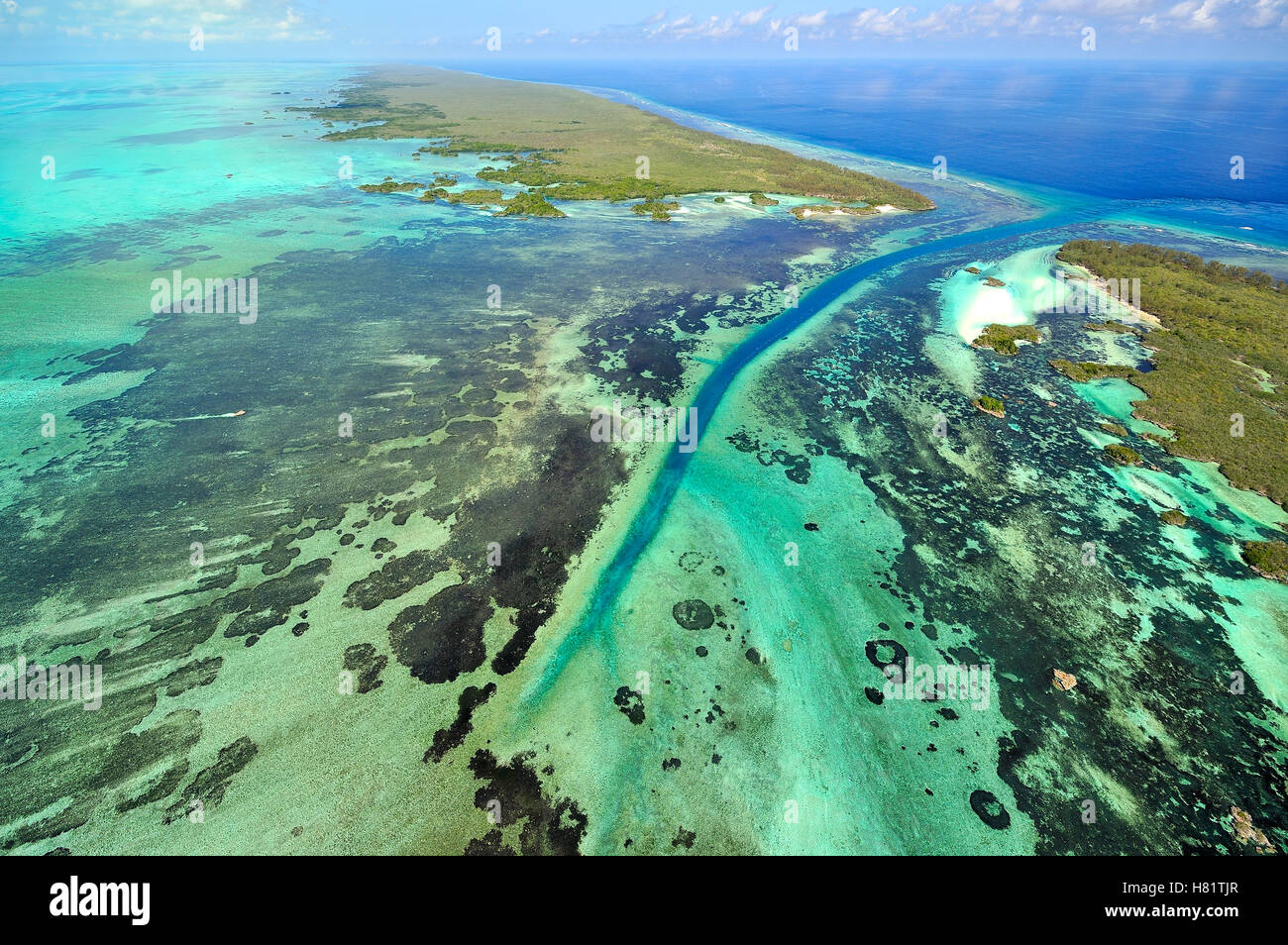 Aerial view of tidal channel in coral which feeds central lagoon ...