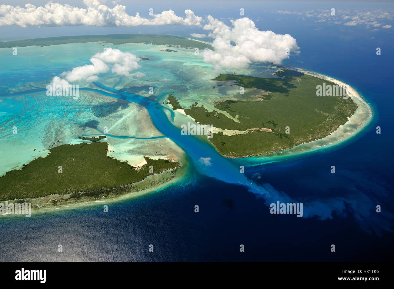 Aerial view of tidal channels feeding central lagoon of raised coral ...