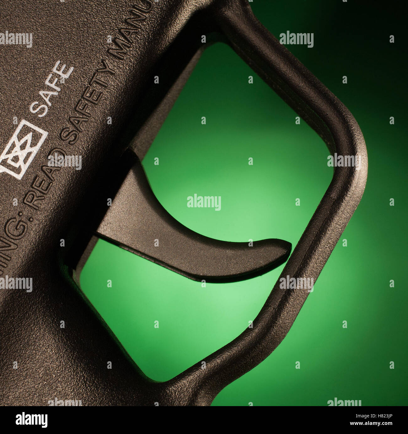 Rifle trigger that has a green background behind Stock Photo - Alamy