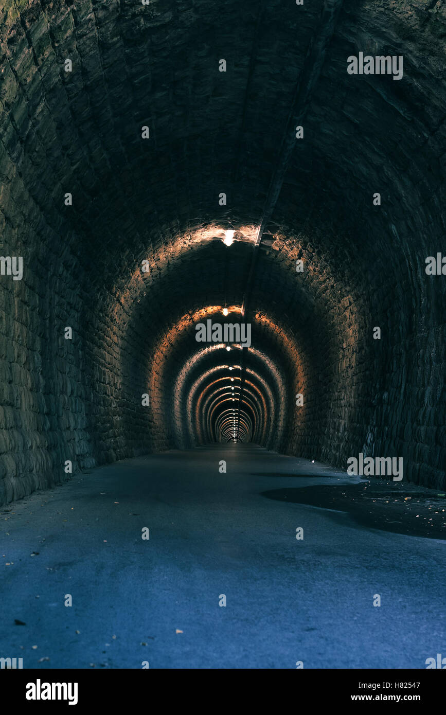 Old tunnel passageway with asphalt road for bikers and pedestrians ...