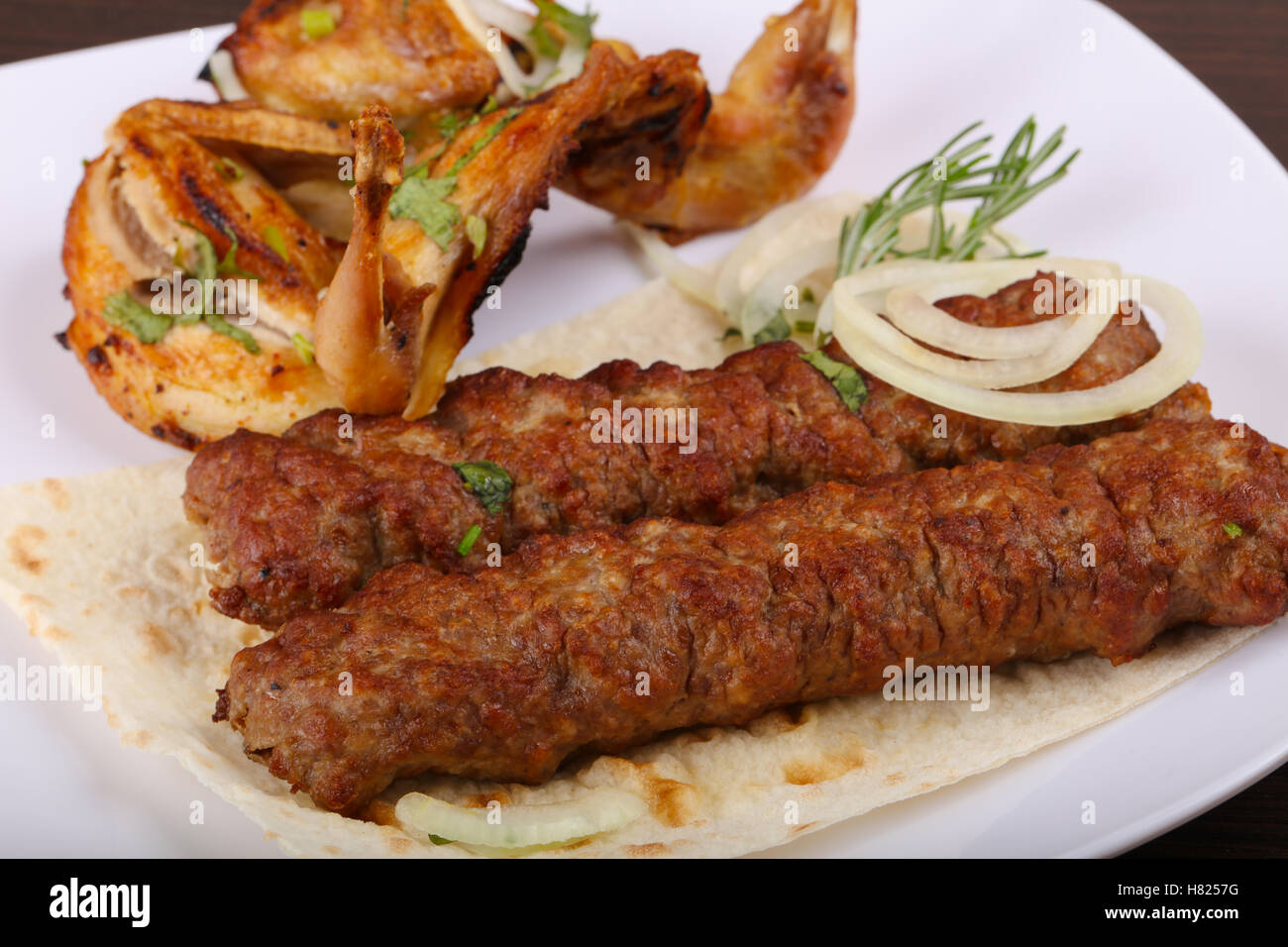 Beef kebab and grilled Quail with onion and parsley Stock Photo - Alamy