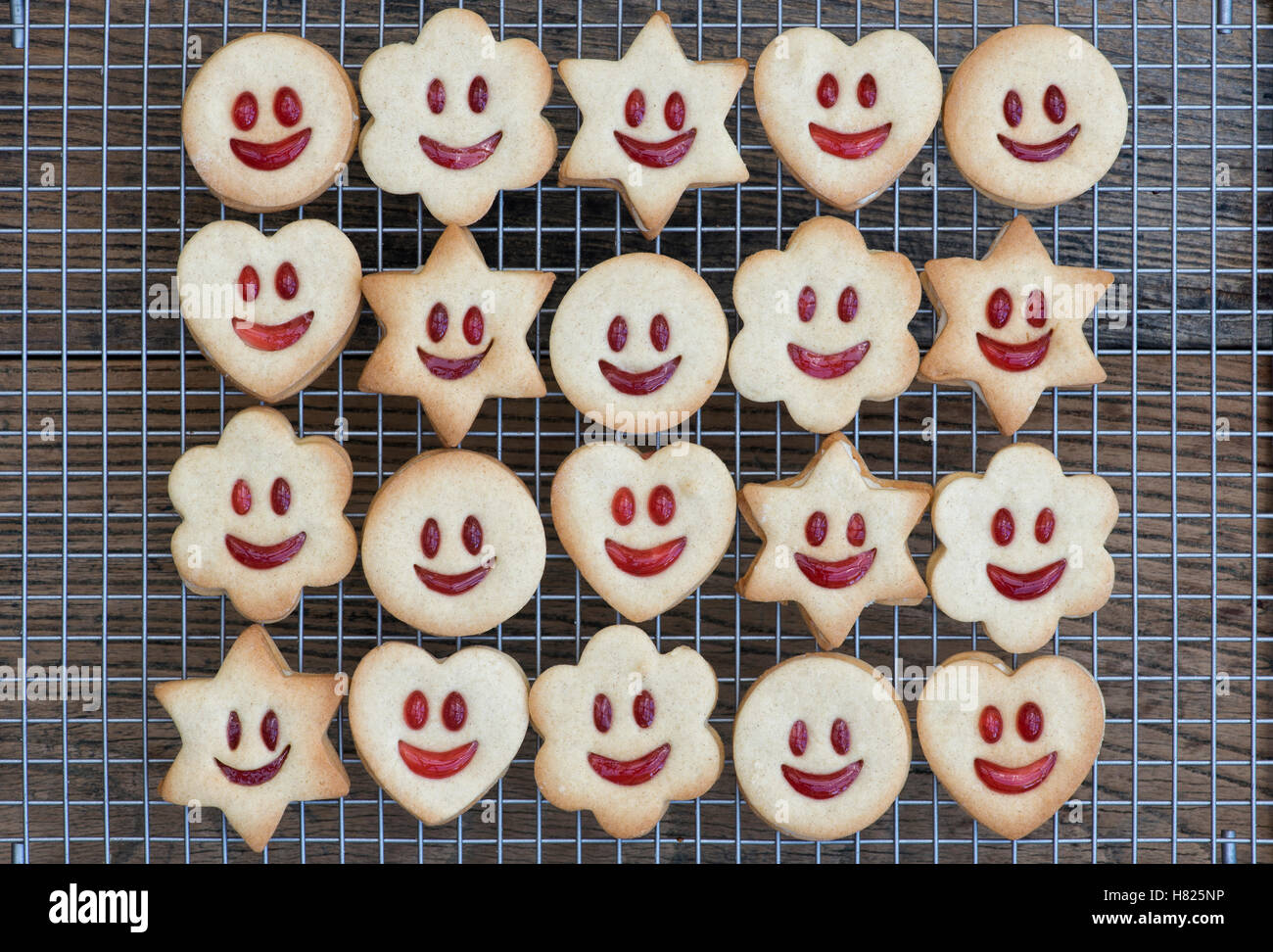 Homemade Jammie Dodgers. Smiling face biscuits faces on a wire rack ...