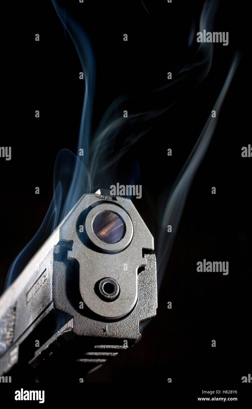Barrel of a handgun glowing as smoke rises Stock Photo - Alamy
