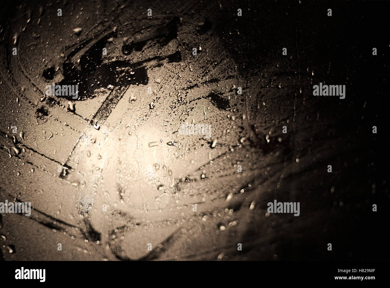 Abstract light effects on a wet glass pane with water drops Stock Photo ...