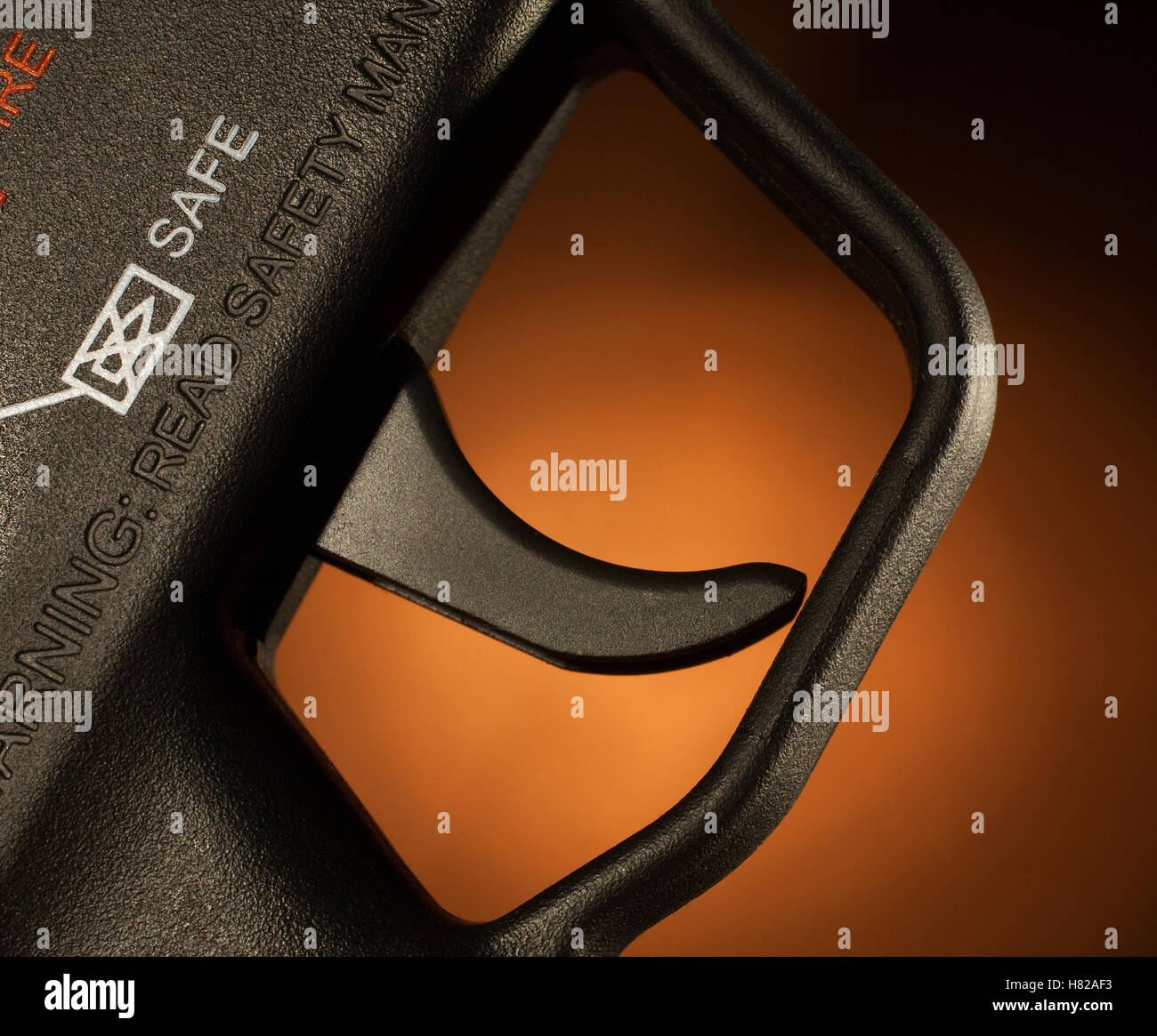 Assault rifle trigger that has a brown color behind Stock Photo - Alamy