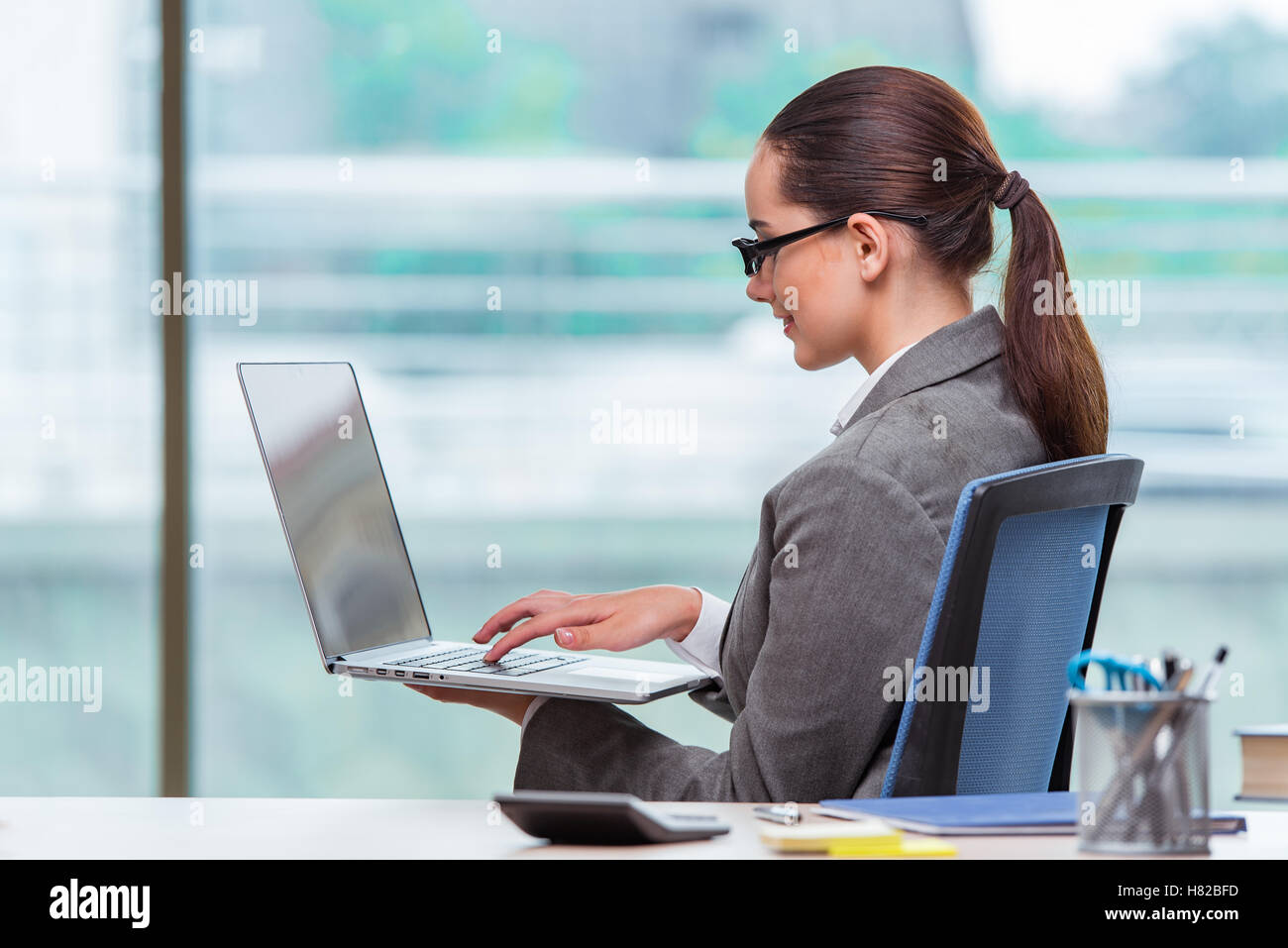 Young assistant working in the office Stock Photo - Alamy