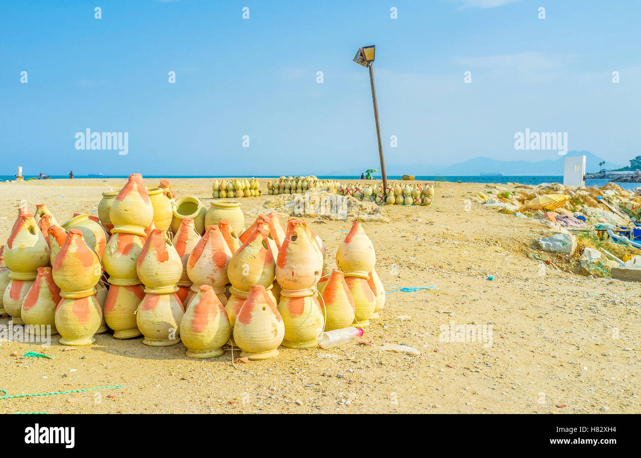 The earthenware pots for catching octopuses get dry in the sun ...